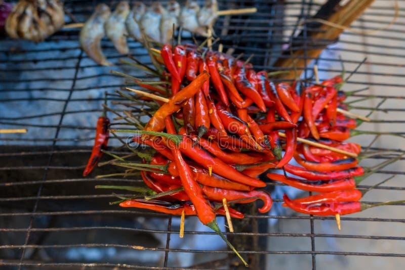 Close Up View of Red Hot Thai Papers Roasted on the Grill Stock Photo ...