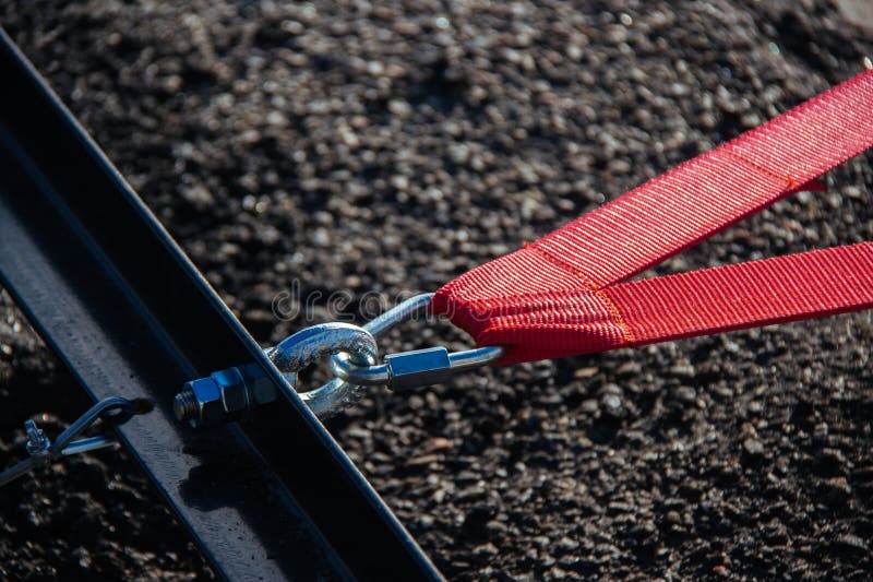 A Close-up View of a Red Strap Secured with a Metal Clasp, Emphasizing ...