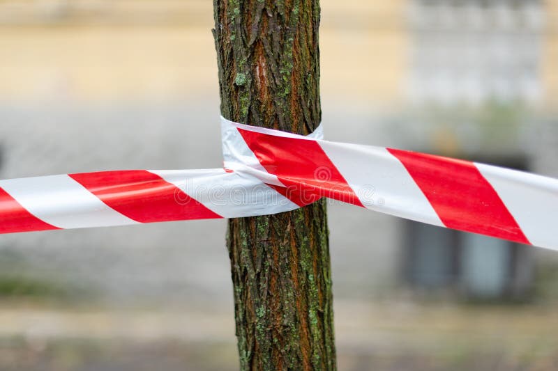 A Close-up View of Red and White Striped Caution Tape Wrapped Around a ...