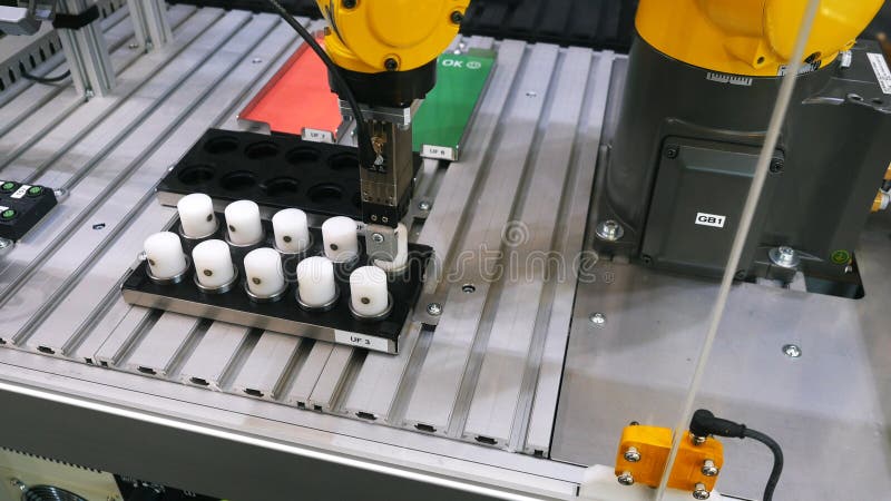 Close-up View of Robot Machine Relocating Some Small White Details ...