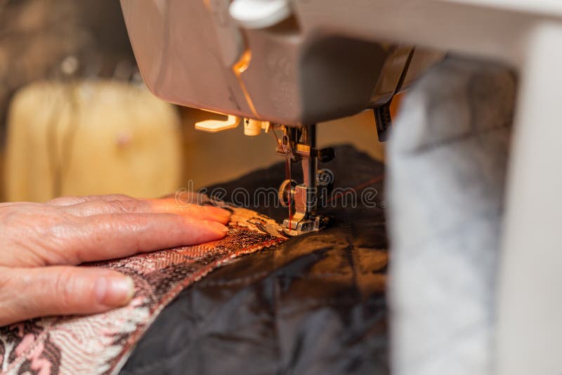 A Close-up View of Sewing Process, Hand of Old Woman Using Sewing ...
