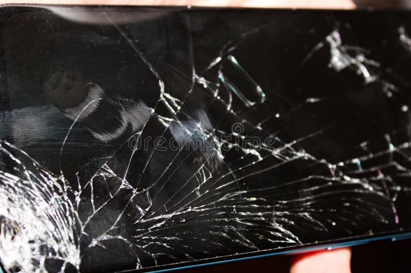 Close-up View of a Shattered Smartphone Screen Showing Intricate Cracks ...