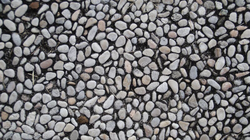 Close-Up View of Small Round Pebble Stones in Various Shades on a Black ...