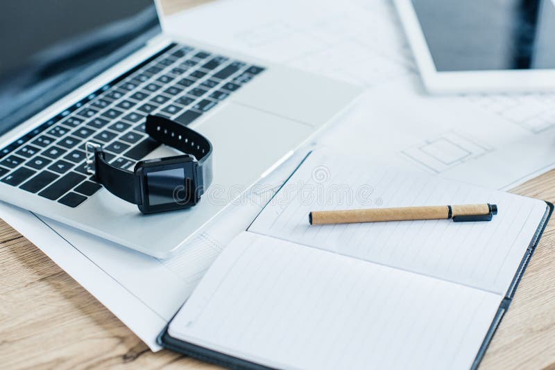 Close-up View of Smartwatch, Laptop, Digital Tablet, Blueprint and ...