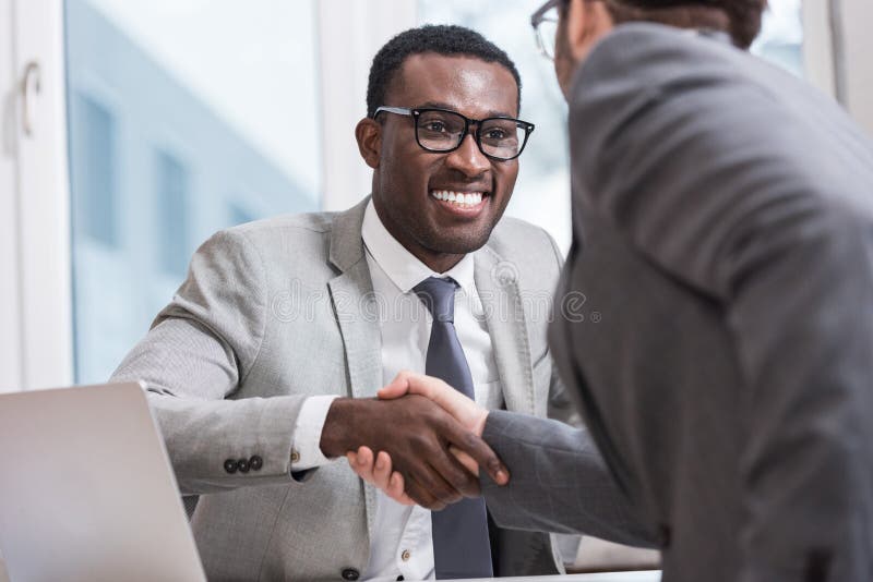 Close Up View of Smiling Multiethnic Businessmen Shaking Hands Stock ...