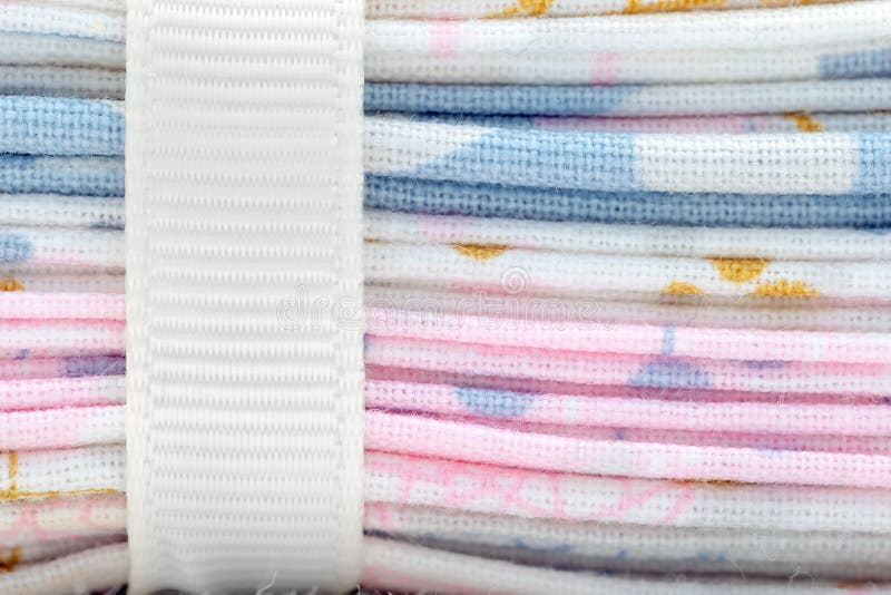A Close Up View of a Stack of Fat Quarters Wrapped with White Ribbon ...