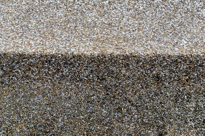 Close-up View of Textured Concrete Surface Featuring Small Pebbles and ...