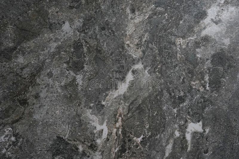 A Close-up View of a Textured, Dark Gray Stone Surface with Natural ...