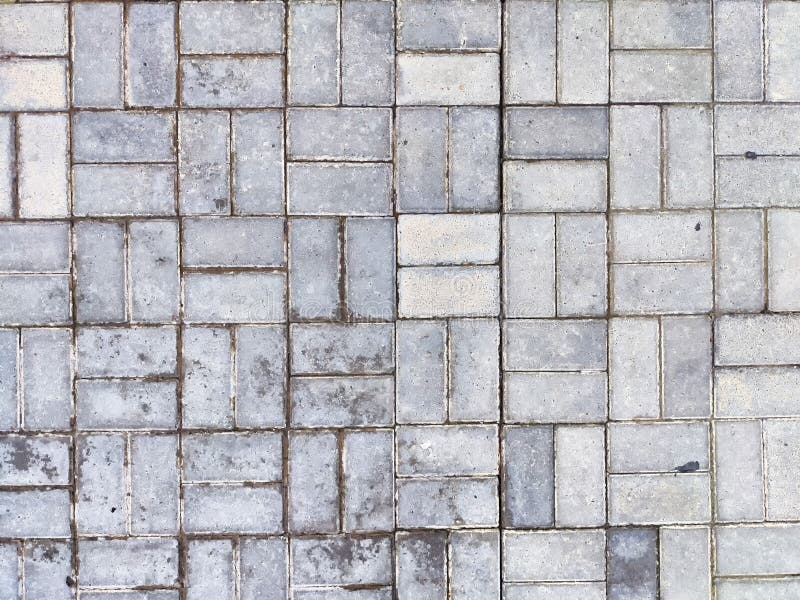 A Close-up View of a Textured Pavement with Interlocking Gray Tiles ...
