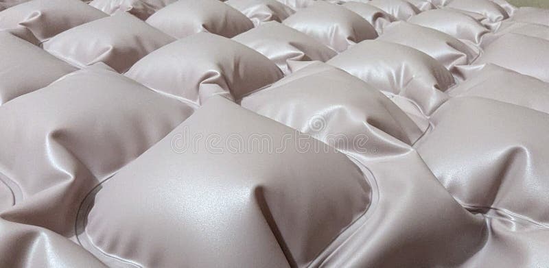 A Close-up View of a Textured, Plush Mattress with Stylized Cube ...