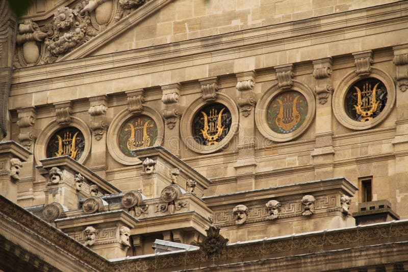 A Clock on the Side of a Large Building with Windows Stock Image ...