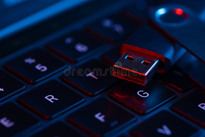 Close-up View of USB Stick on a Laptop Keyboard with Neon Lights ...