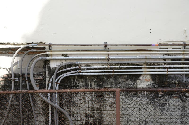 Electrical Conduits on a Building Attached To a White Wall Stock Image ...
