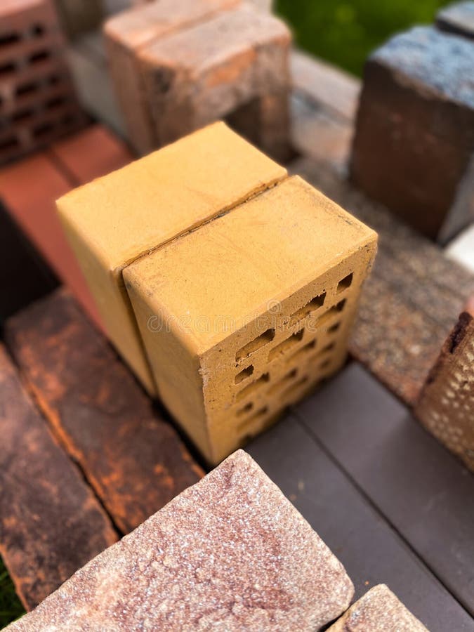 Different Types of Bricks Stacked Beautifully on Green Grass Stock ...