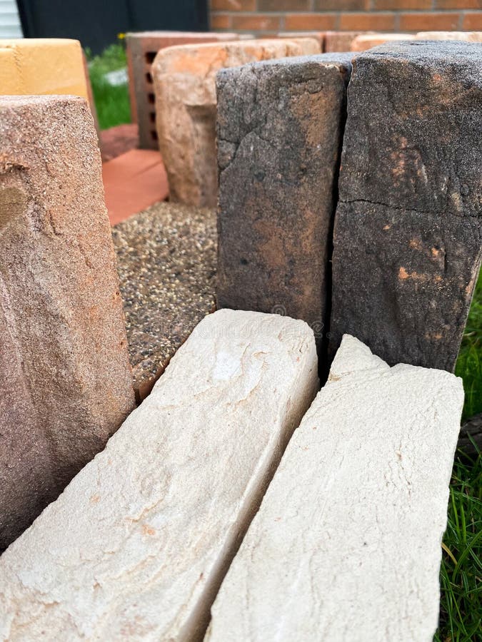 Different Types of Bricks Stacked Beautifully on Green Grass Stock ...