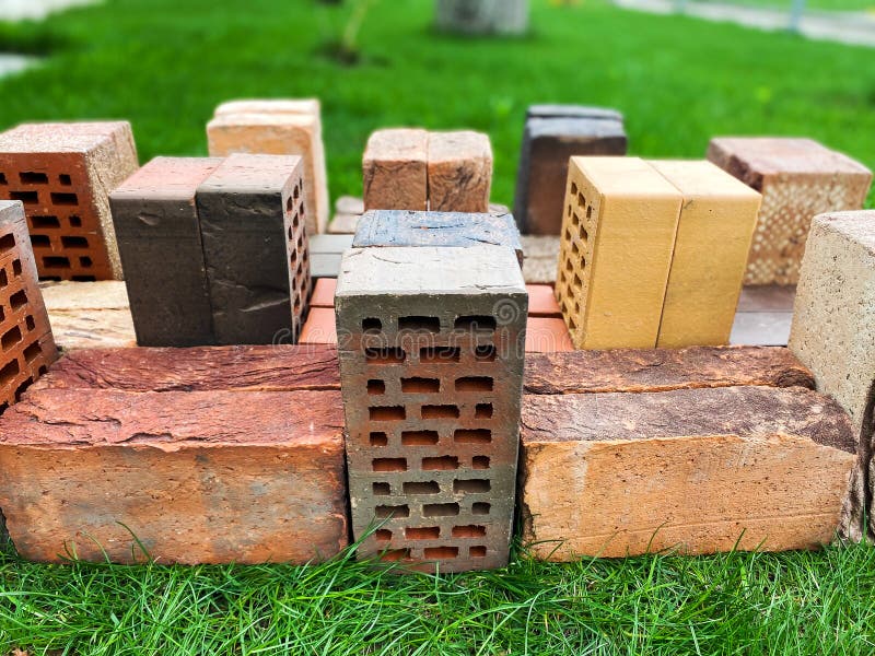Different Types of Bricks Stacked Beautifully on Green Grass Stock ...