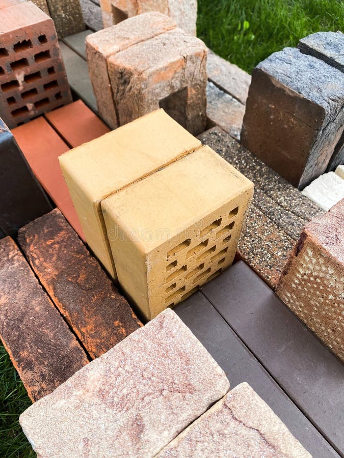 Different Types of Bricks Stacked Beautifully on Green Grass Stock ...