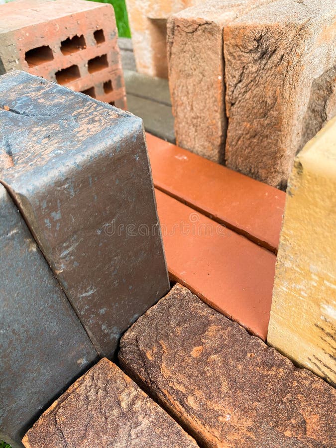 Different Types of Bricks Stacked Beautifully on Green Grass Stock ...