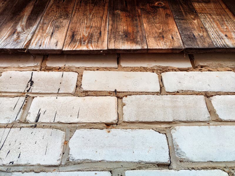 Textured Wall Composed of White Bricks and Weathered Wooden Planks in a ...