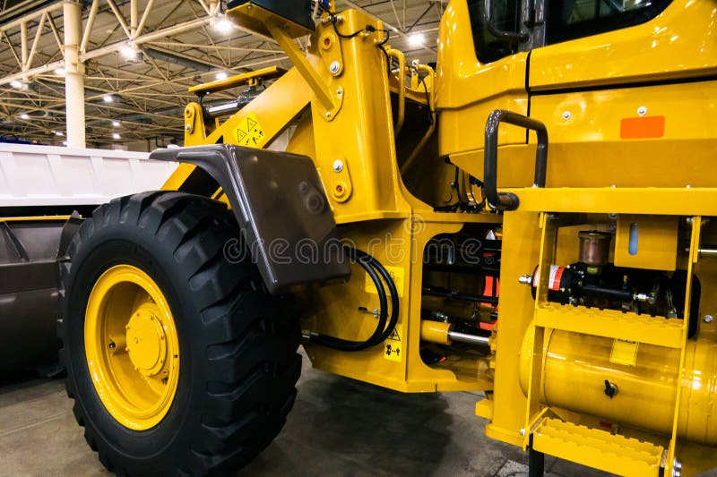 A Close-up View of a Wheel Loader Focusing on the Tire, Fender, and ...