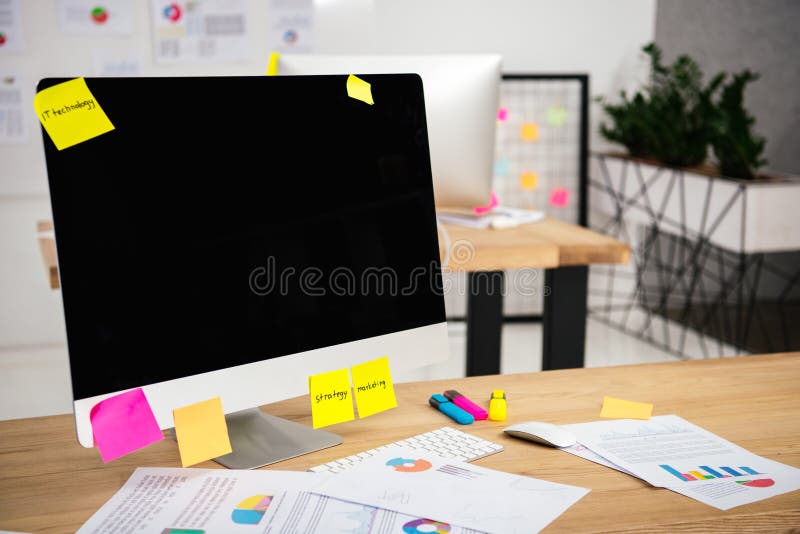 Close Up View of Workplace with Blank Computer Screen, Sticky Notes and ...