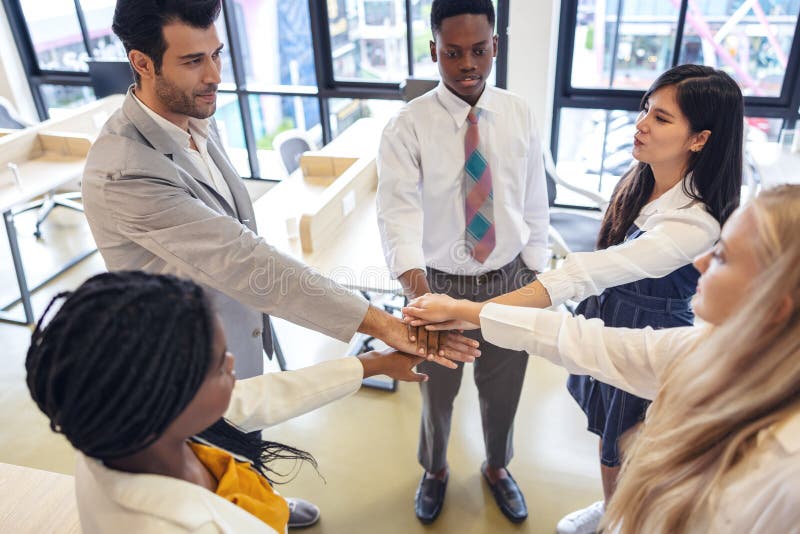 Close Up View of Young Business People Putting Their Hands Together ...