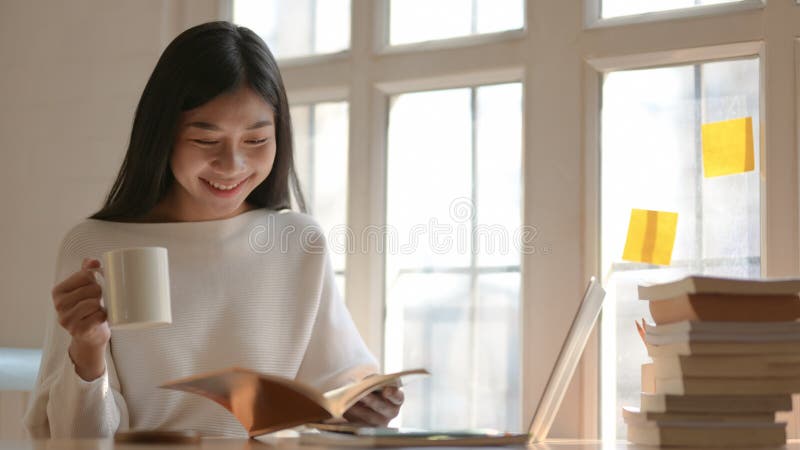 Close Up View of College Girl Reading Book in Simple Workplace Stock ...