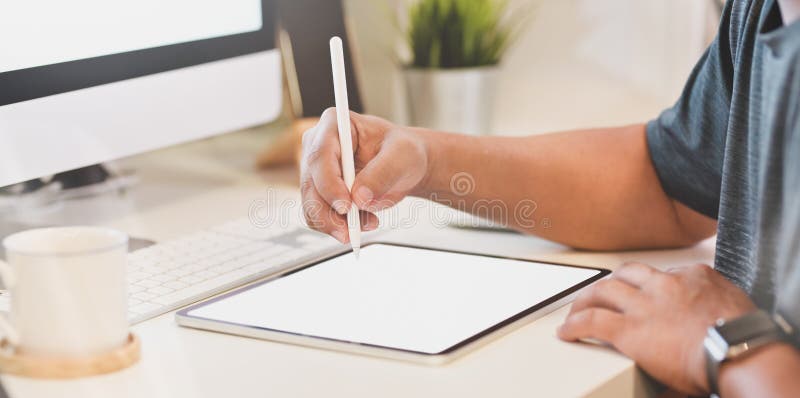 Close-up View of Young Man Using Tablet in Workplace Stock Photo ...