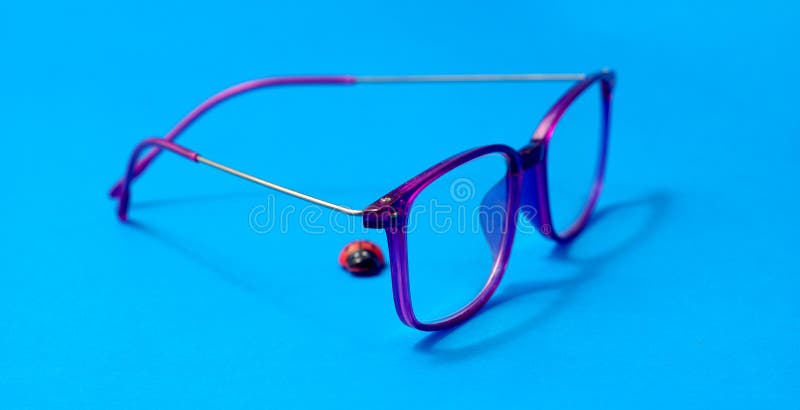 Close Up of Vivid Pink Plastic Eyeglass Frames on Blue Background ...