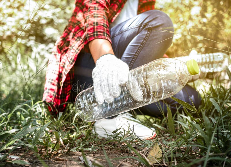 Close Up of Volunteers Sit and Picking Up Garbage in the Park ...