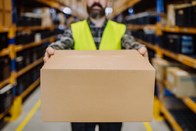Close-up of Warehouse Worker Stocking Goods in a Warehouse. Stock Image ...