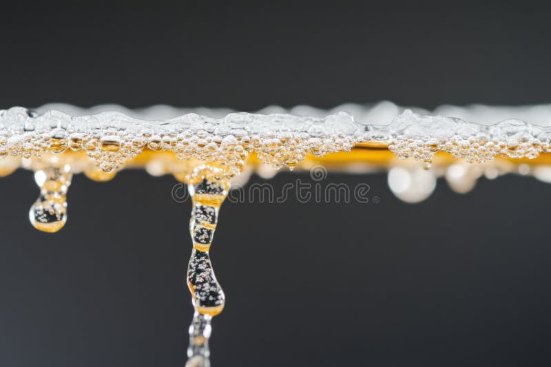 Close-up of Water and Amber-colored Liquid Flowing with Bubbles ...