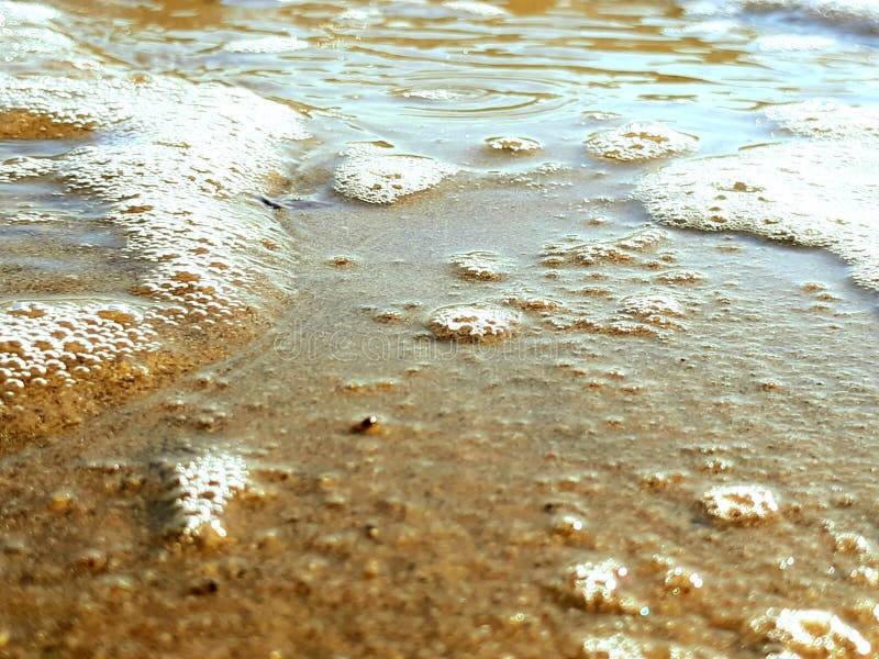 Close Up of Water, Bubbles and Sand on the Beach Stock Image - Image of ...