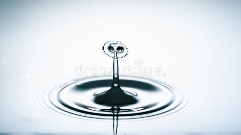 Close-up of a Water Drop Falling on Water Surface Stock Image - Image ...