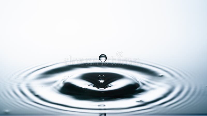 Close-up of a Water Drop Falling on Water Surface Stock Image - Image ...