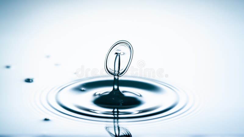 Close-up of a Water Drop Falling on Water Surface Stock Image - Image ...