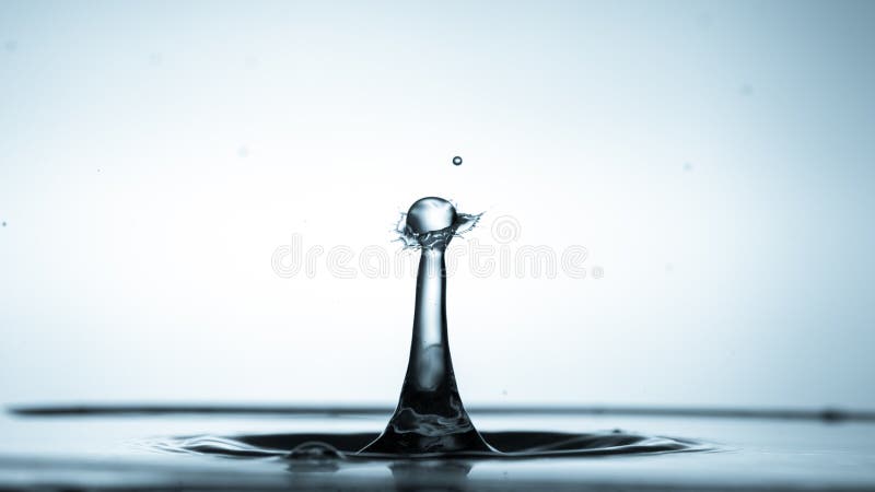 Close-up of a Water Drop Falling on Water Surface Stock Image - Image ...
