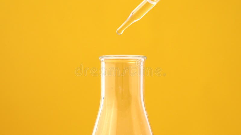 Close-up of Water Drops Falling from a Dropper into a Glass Bottle ...