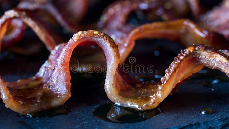 Close Up of a Wavy Strip of Maple Pepper Bacon, Hot Off the Griddle ...