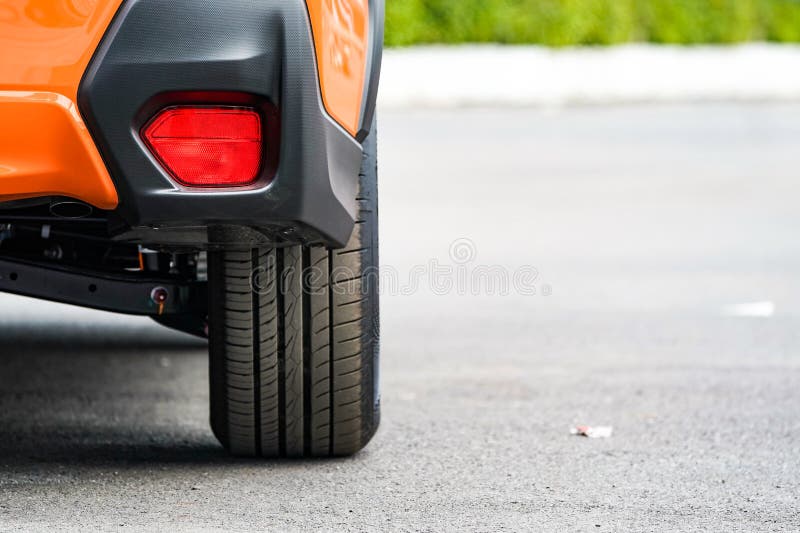 Close Up Wheel of Orange Car on the Road Stock Photo - Image of asphalt ...