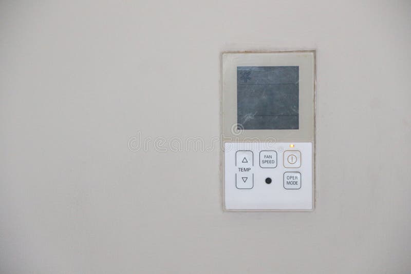 Close-up of a White AC Control Unit with a Green Backlit Display ...