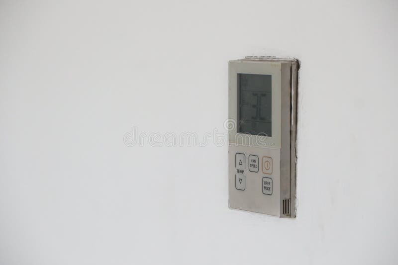 Close-up of a White AC Control Unit with a Green Backlit Display ...