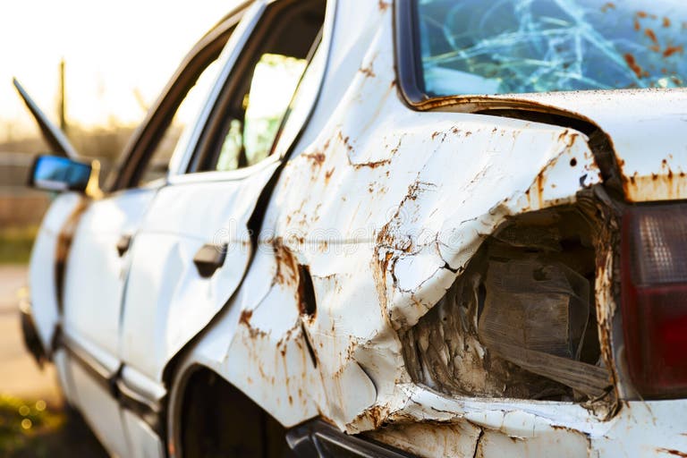 Close-up of a White Car with Significant Rust and Damage, Highlighting ...