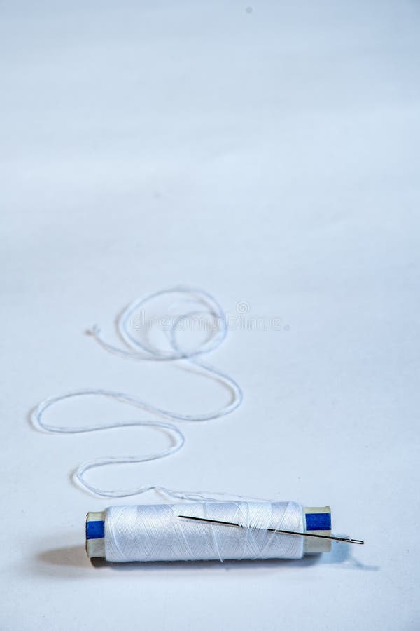 Close-up of a White Color Thread Spool of Sewing Machine with a Needle ...