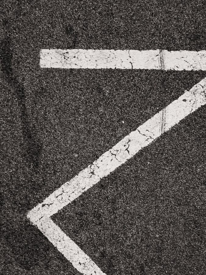 Close-up of a White, Jagged Marking on Asphalt Stock Photo - Image of ...