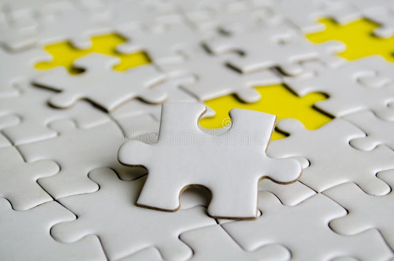Close Up of White Jigsaw Puzzle Pieces Placed on a Bright Yellow ...