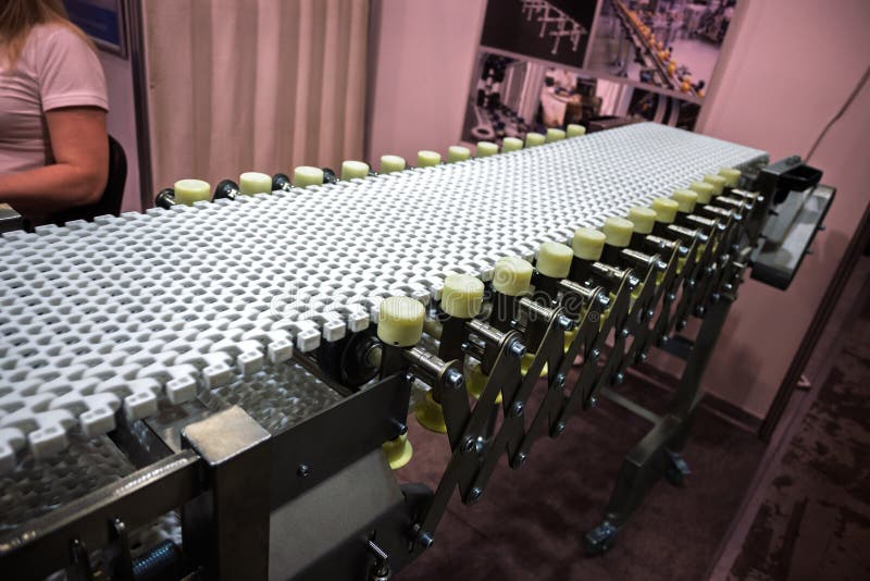 Close-up of a White Modular Plastic Conveyor Belt with Yellow Support ...