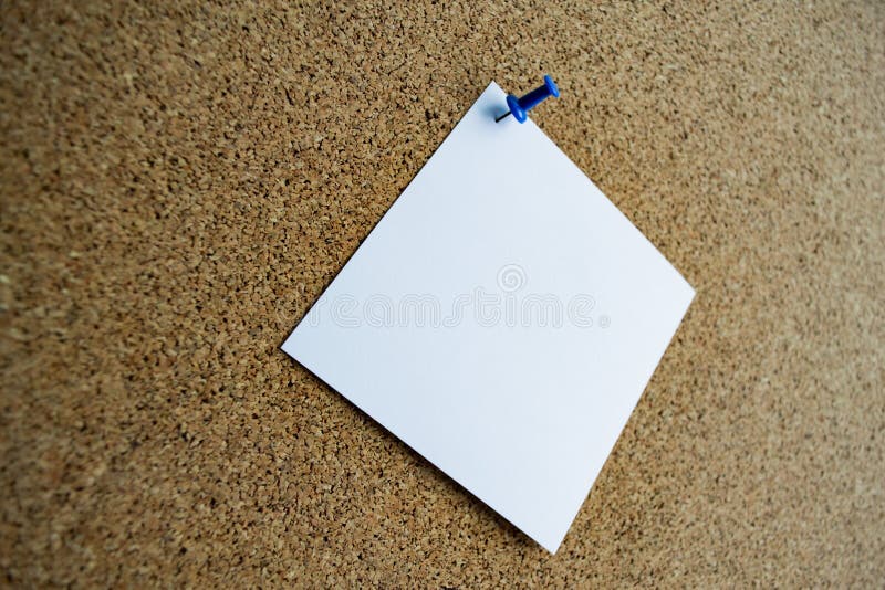 Close-up of a White Paper Note on a Cork Board, Attached with a Blue ...