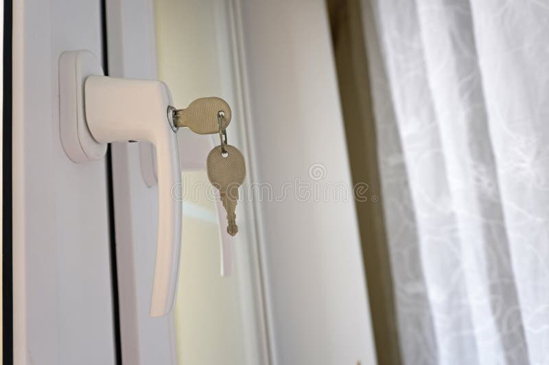 Close-Up of White PVC Window Handle with Inserted Key and Soft Sheer ...