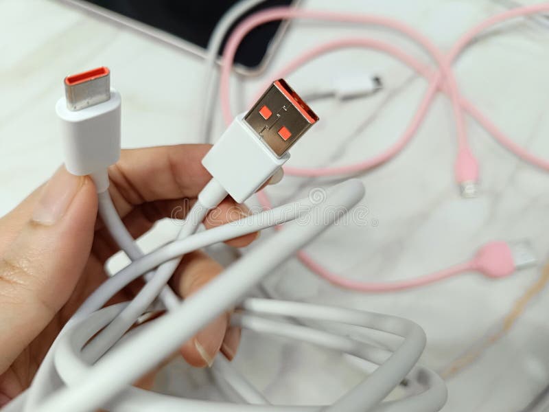 Close-up of a White USB-C Charging Cable Held in Hand, Tangled with ...